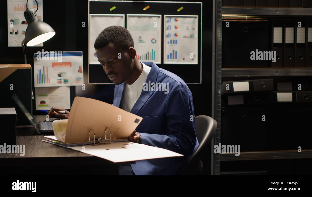 Diligent private investigator grabbing files from shelves to conduct ...