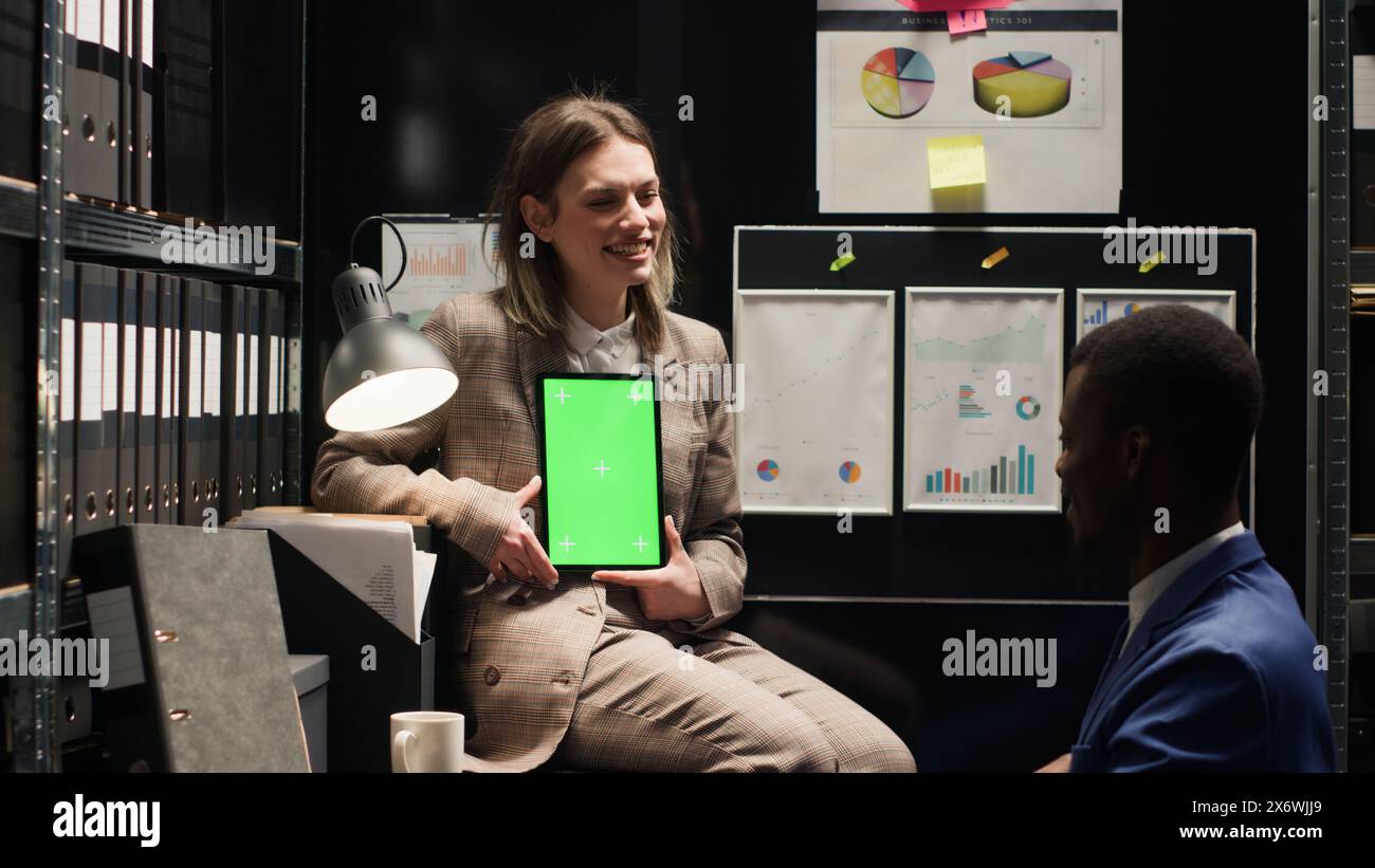 Female inspector speaking with policeman while vertically holding ...