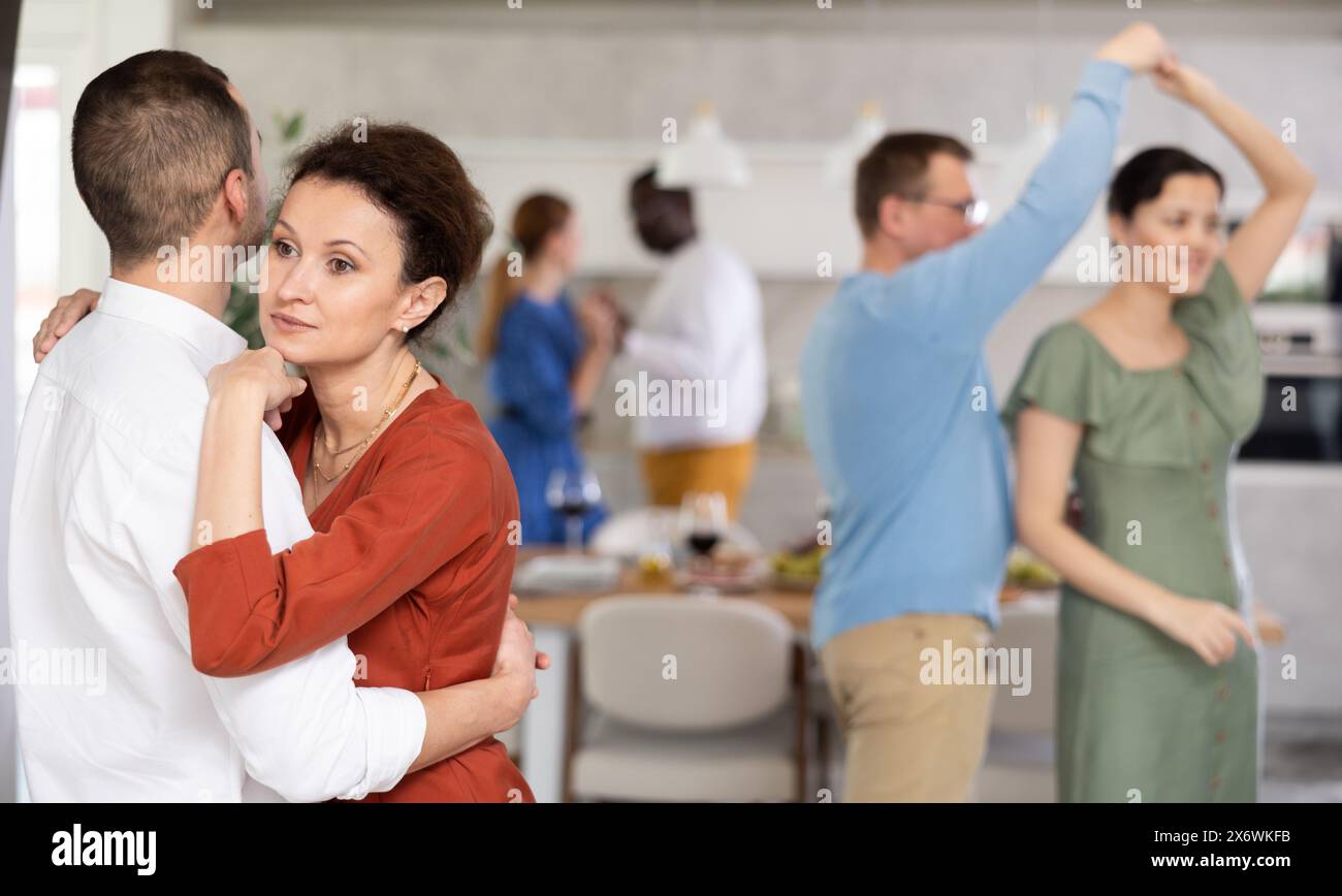 Friends party - men and women of different nationalities dancing slow ...