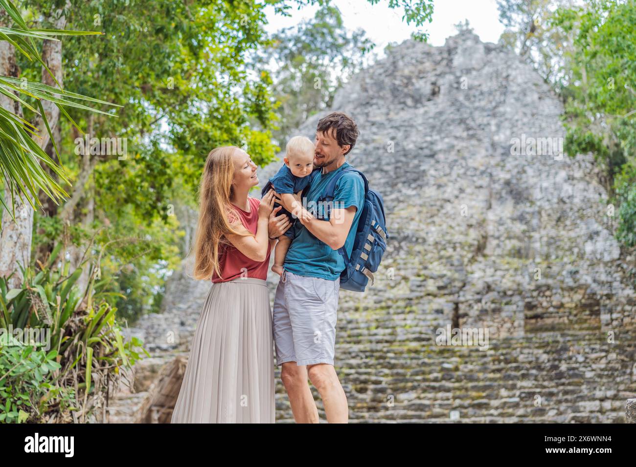 Mom, dad and baby tourists at Coba, Mexico. Ancient mayan city in ...