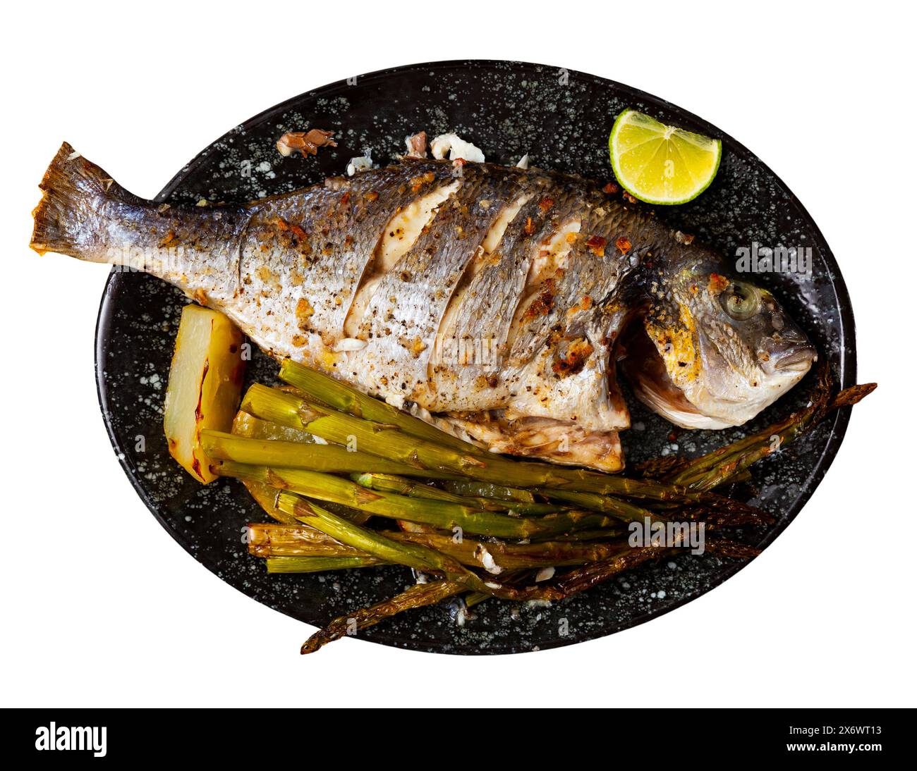 Dorada fish served with potatoes and asparagus Stock Photo - Alamy