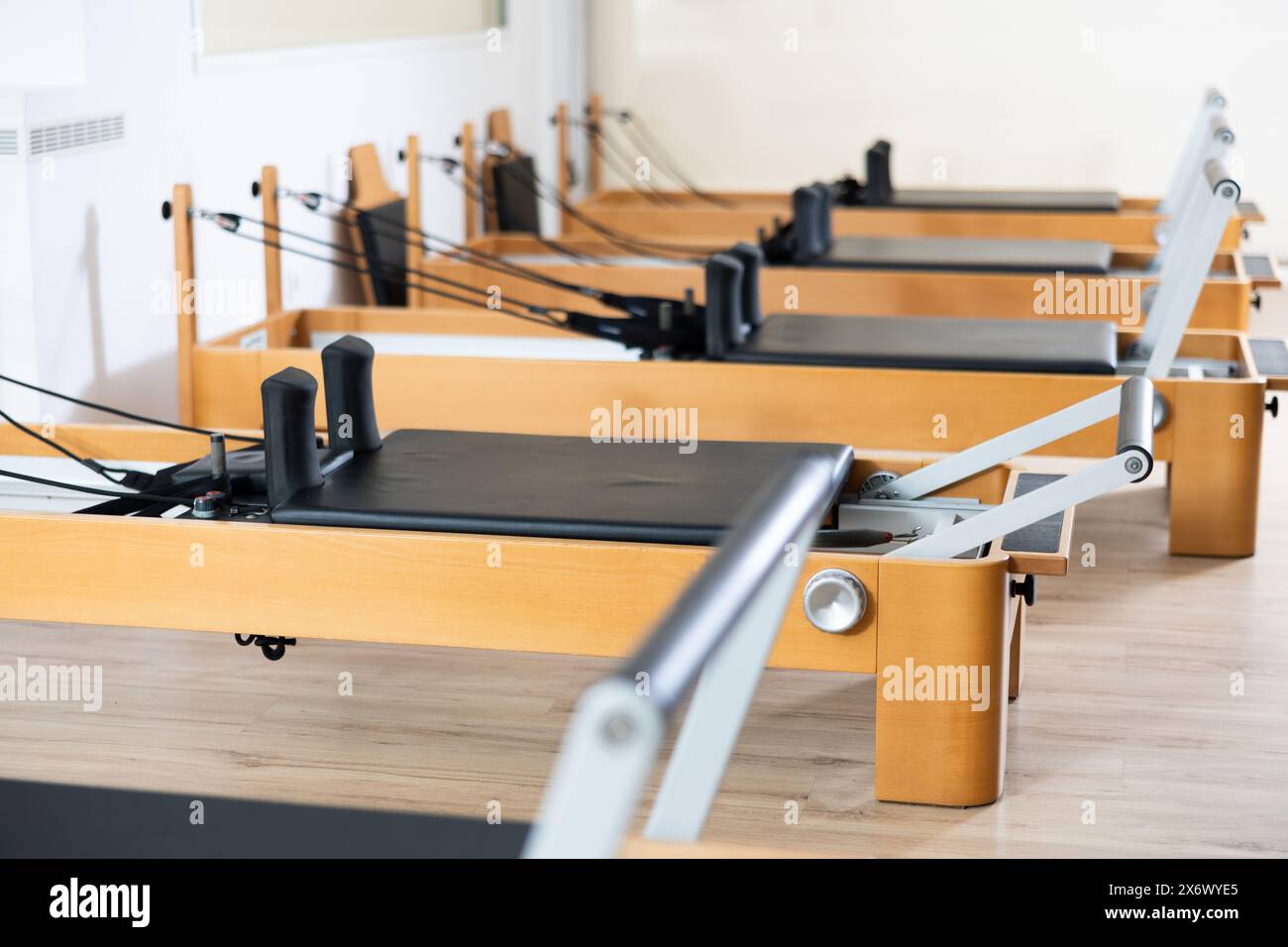 Interior of modern Pilates studio with trapeze tables for exercises ...