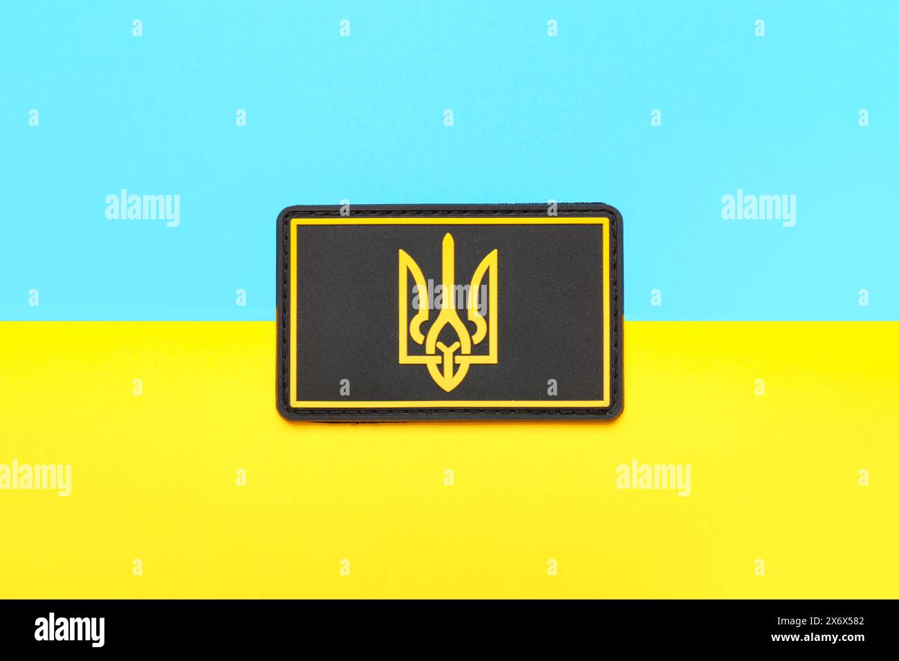 Military badge with trident on blue and yellow background Stock Photo ...
