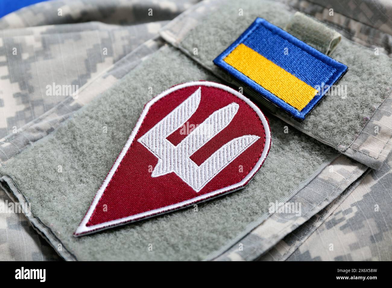 Military uniform with badge of Ukrainian army and flag of Ukraine ...