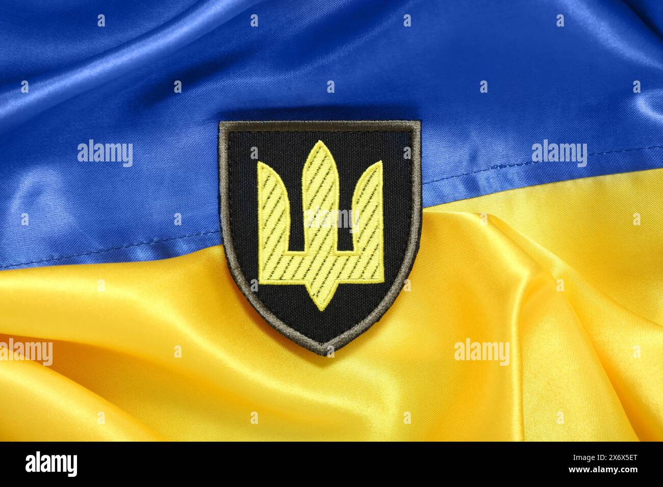 Military badge with trident on flag of Ukraine, closeup Stock Photo - Alamy