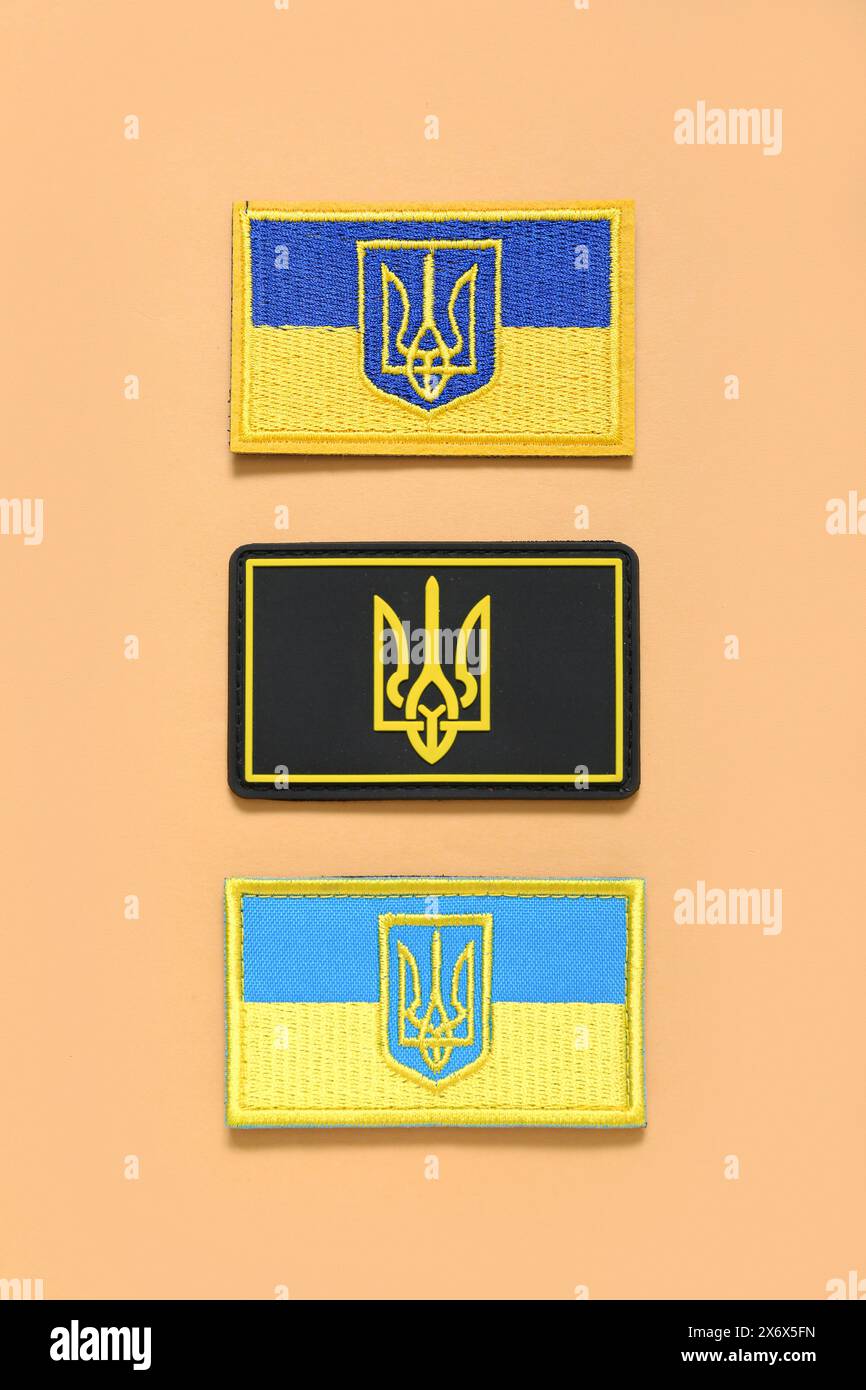 Different military badges of Ukrainian army with trident on beige ...