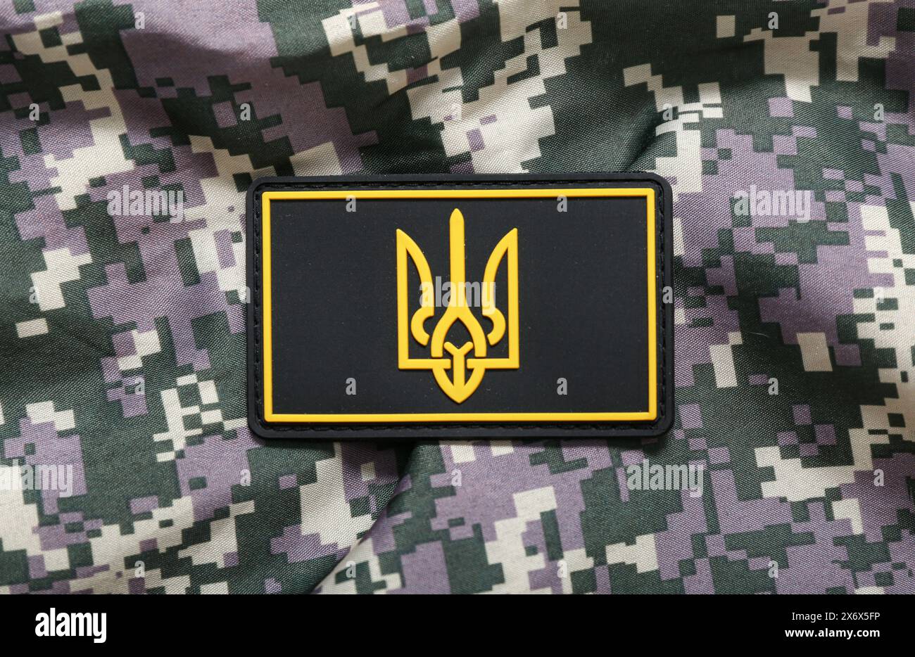 Military badge of Ukrainian army with trident on camouflaged uniform ...