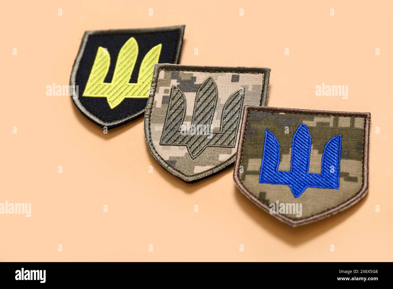 Different military badges of Ukrainian army with trident on beige ...