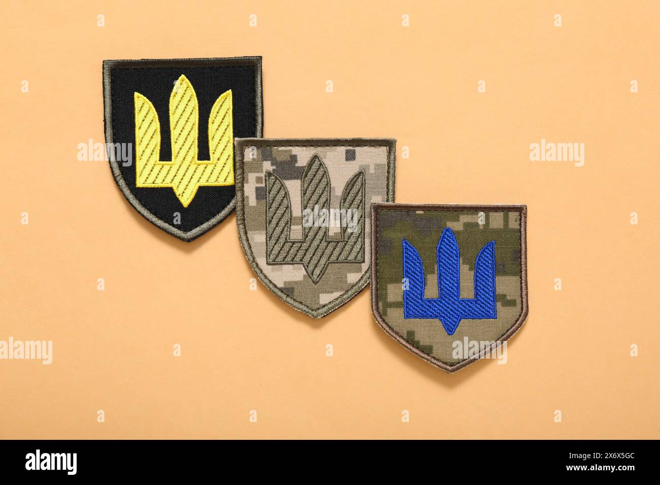 Different military badges of Ukrainian army with trident on beige ...