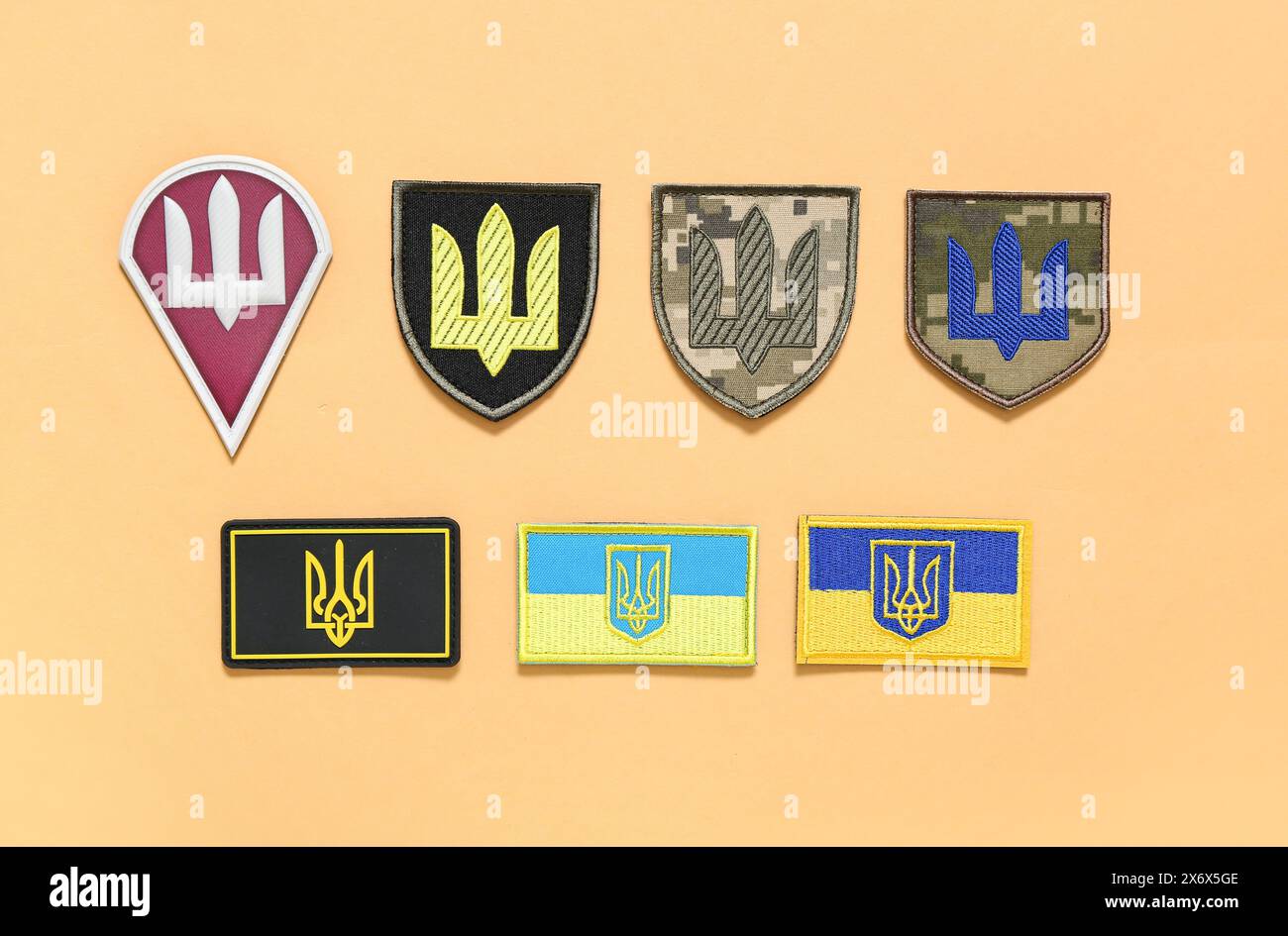 Different military badges of Ukrainian army with trident on beige ...