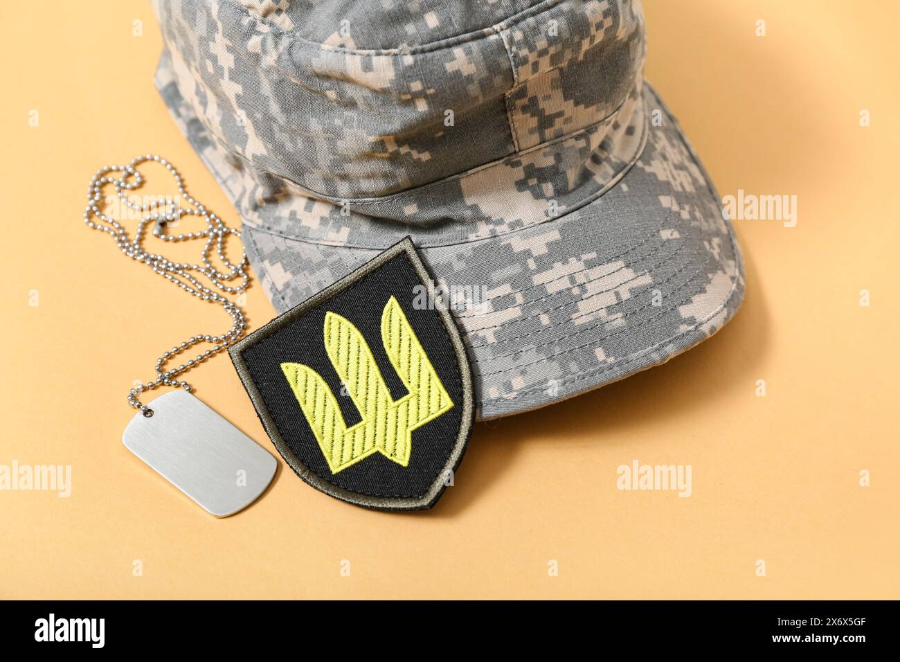 Badge of Ukrainian army with trident, military tag and hat on beige ...