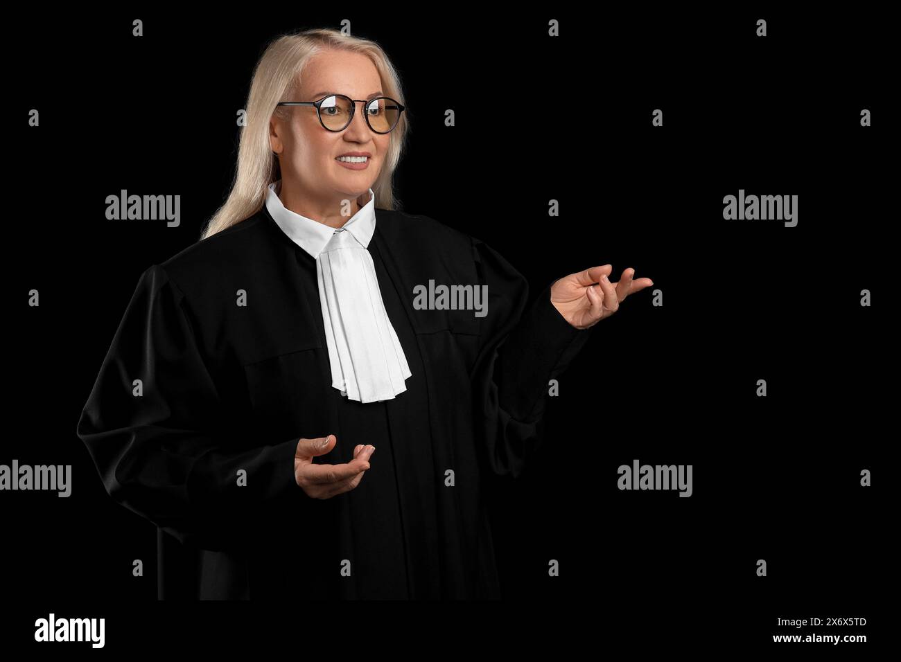 Mature female judge on black background Stock Photo - Alamy