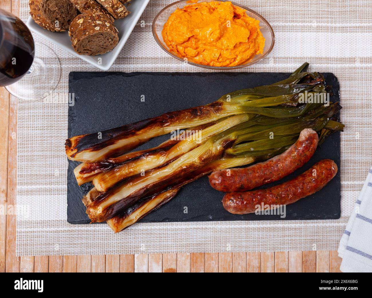 Catalan roasted calcots with salvitxada sauce and grilled botifarra ...