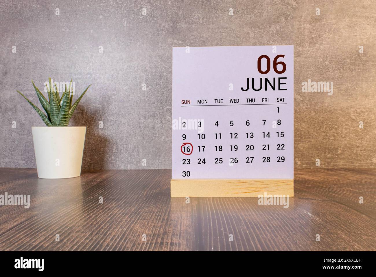 Calendar for June 16, made wooden cubes, on gray background.With an ...