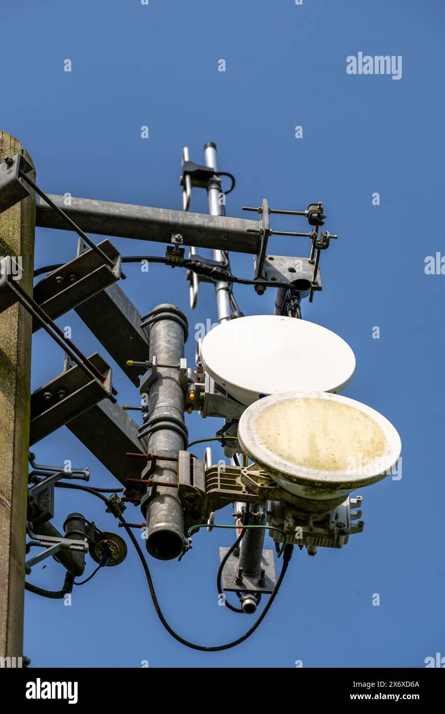 Close-up of a telecommunication tower with various antennas and ...