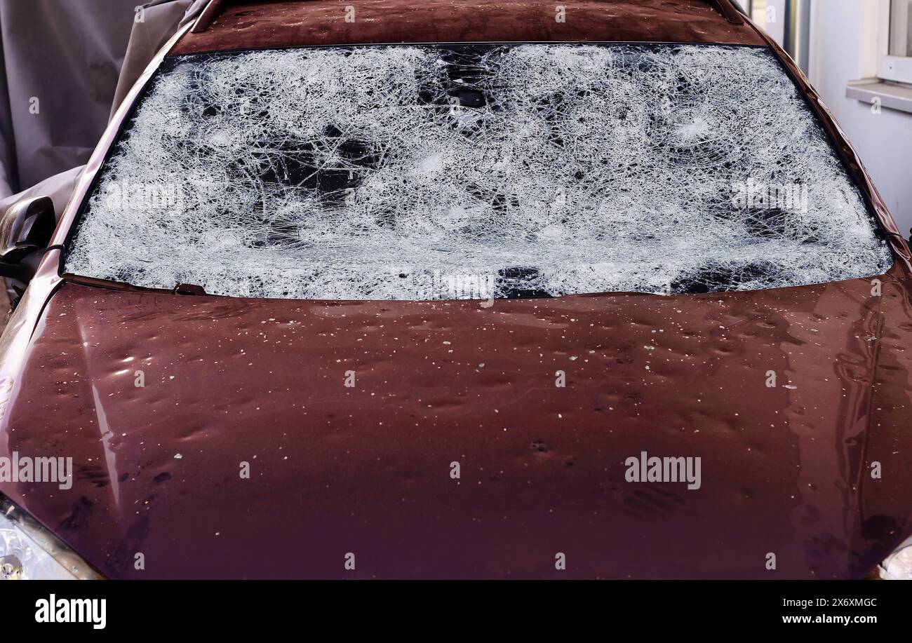 Hail damage to a car. Large hailstones have completely destroyed a car ...