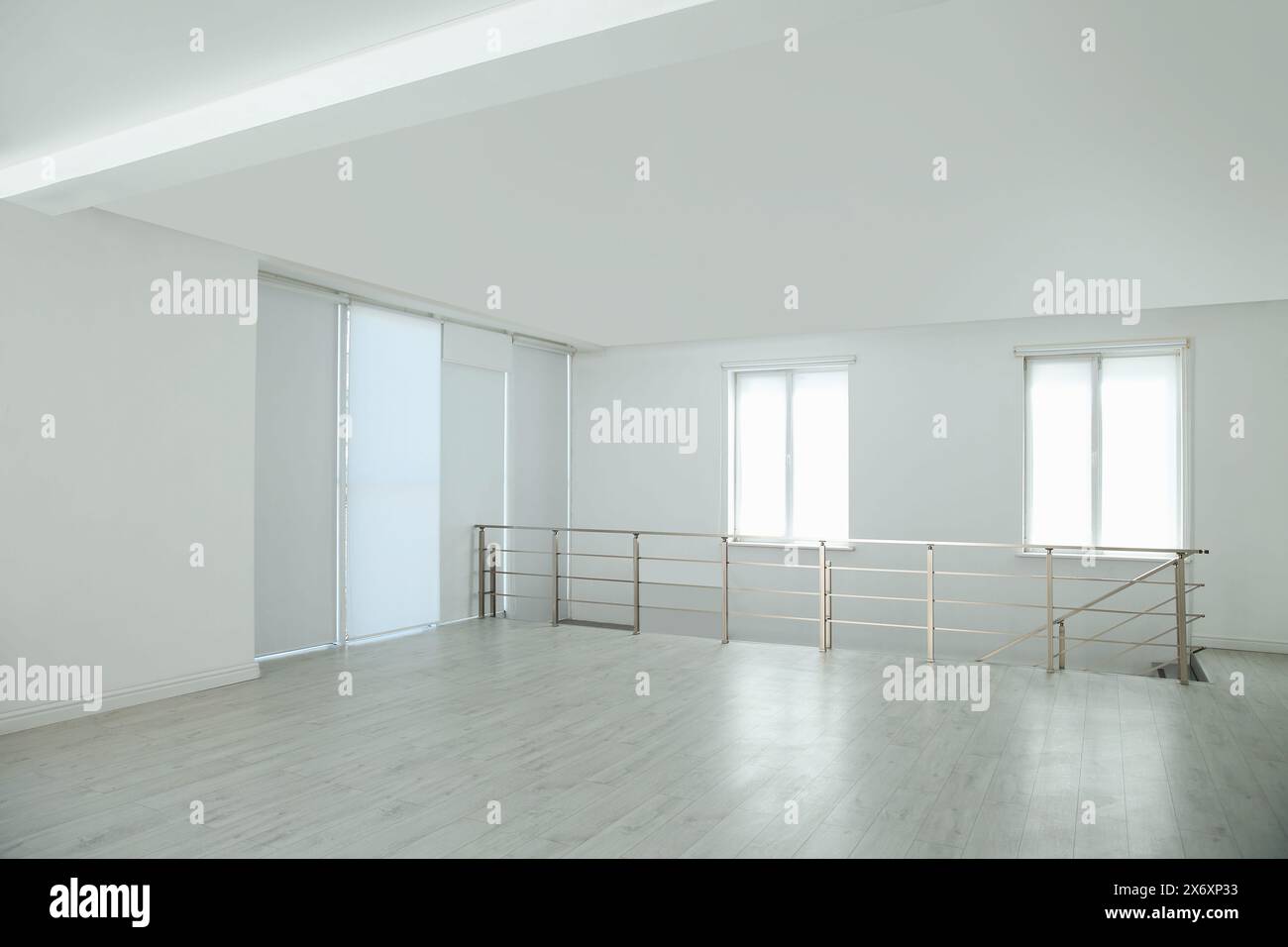 Large empty hall with windows and railings Stock Photo - Alamy