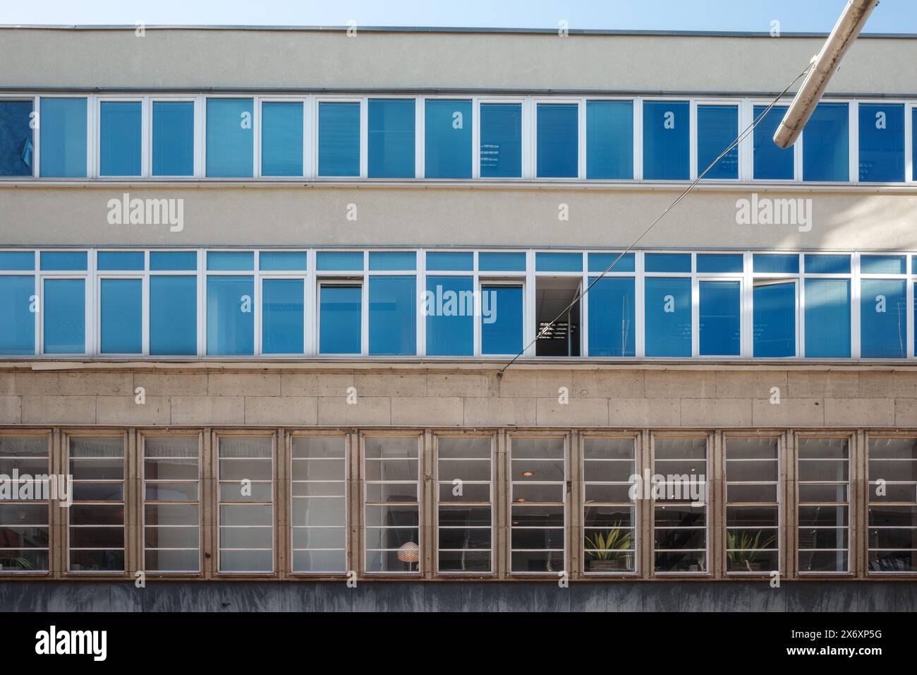 The exterior of a modern office building with a minimalist design. The ...