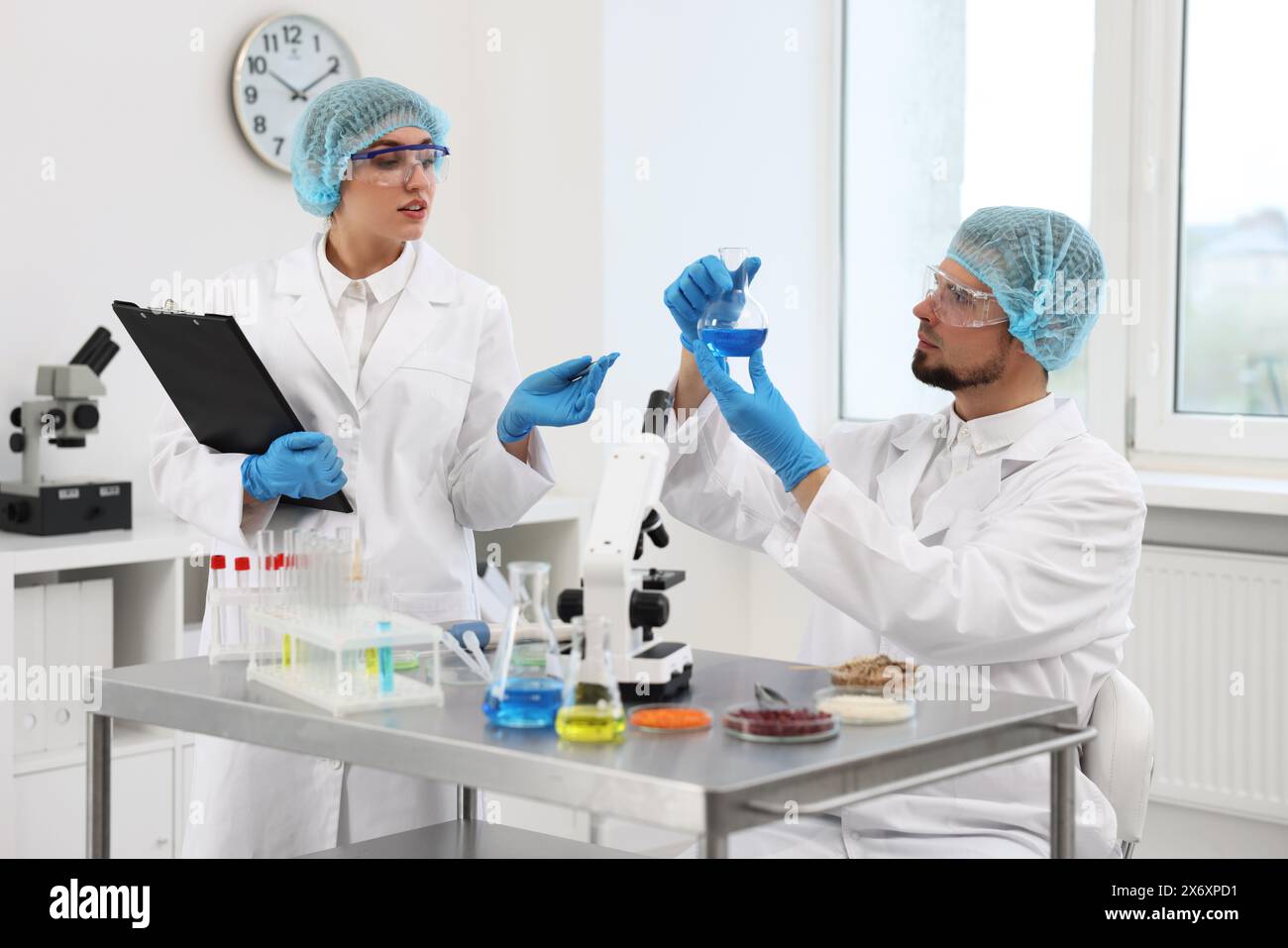 Quality control. Food inspectors checking safety of products in ...