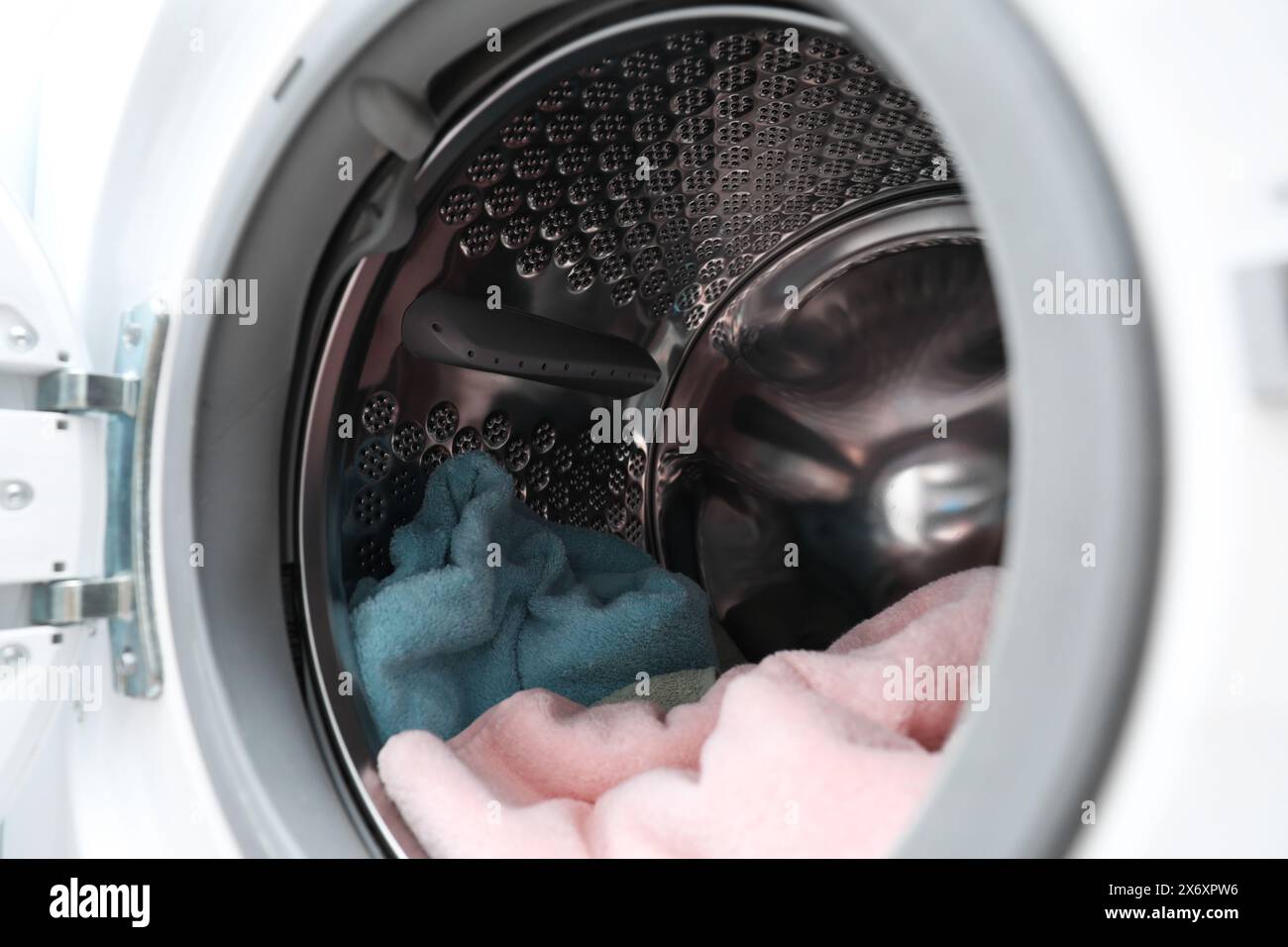 Modern washing machine drum with laundry, closeup Stock Photo - Alamy