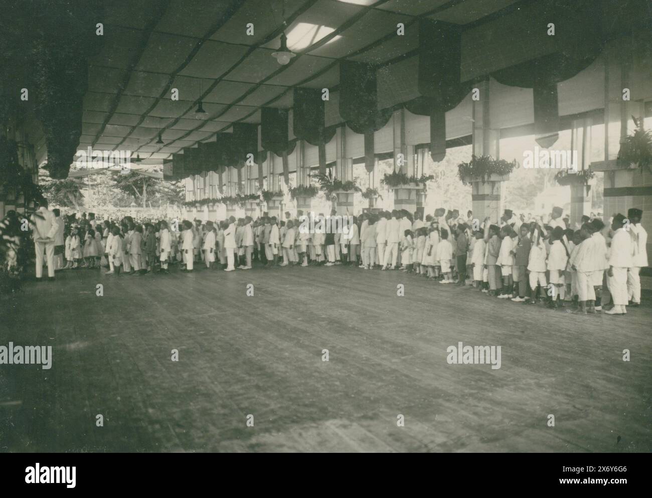 Rows of people in the reception hall of the Sultan of Langkat's palace ...
