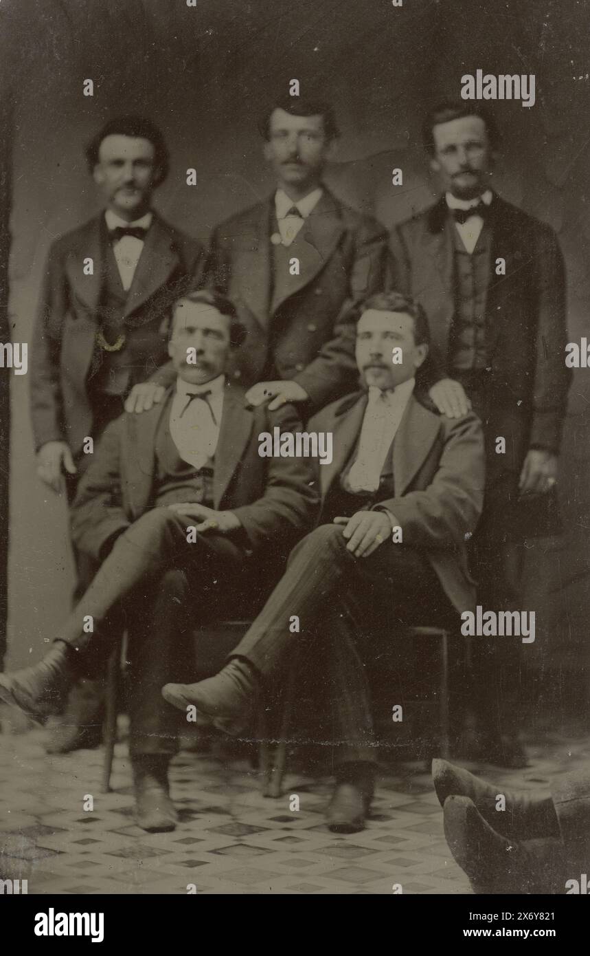 Group portrait of five men, standing and sitting in a studio (far right ...