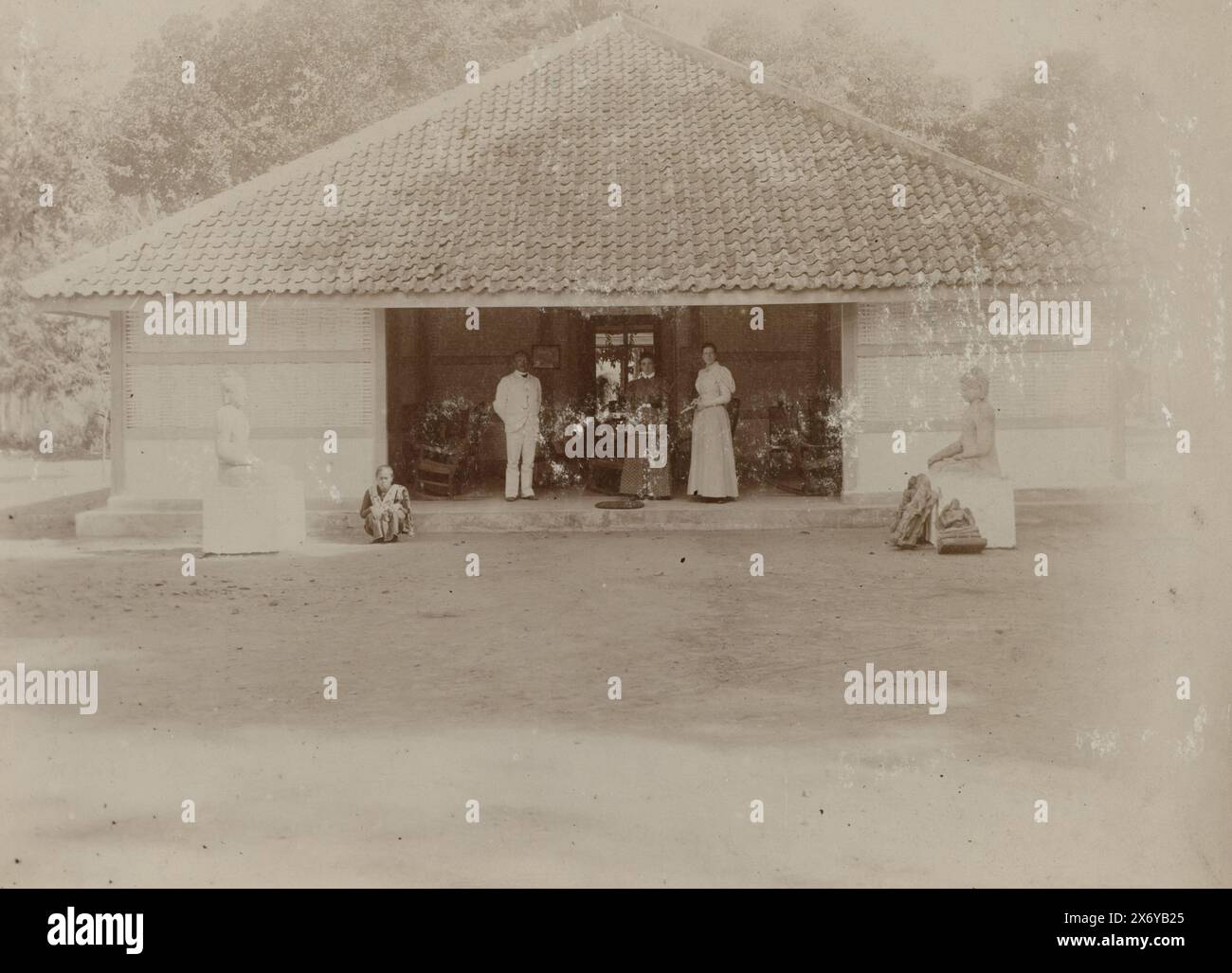 Dutch people in front of a house with Buddha statues in the Dutch East ...