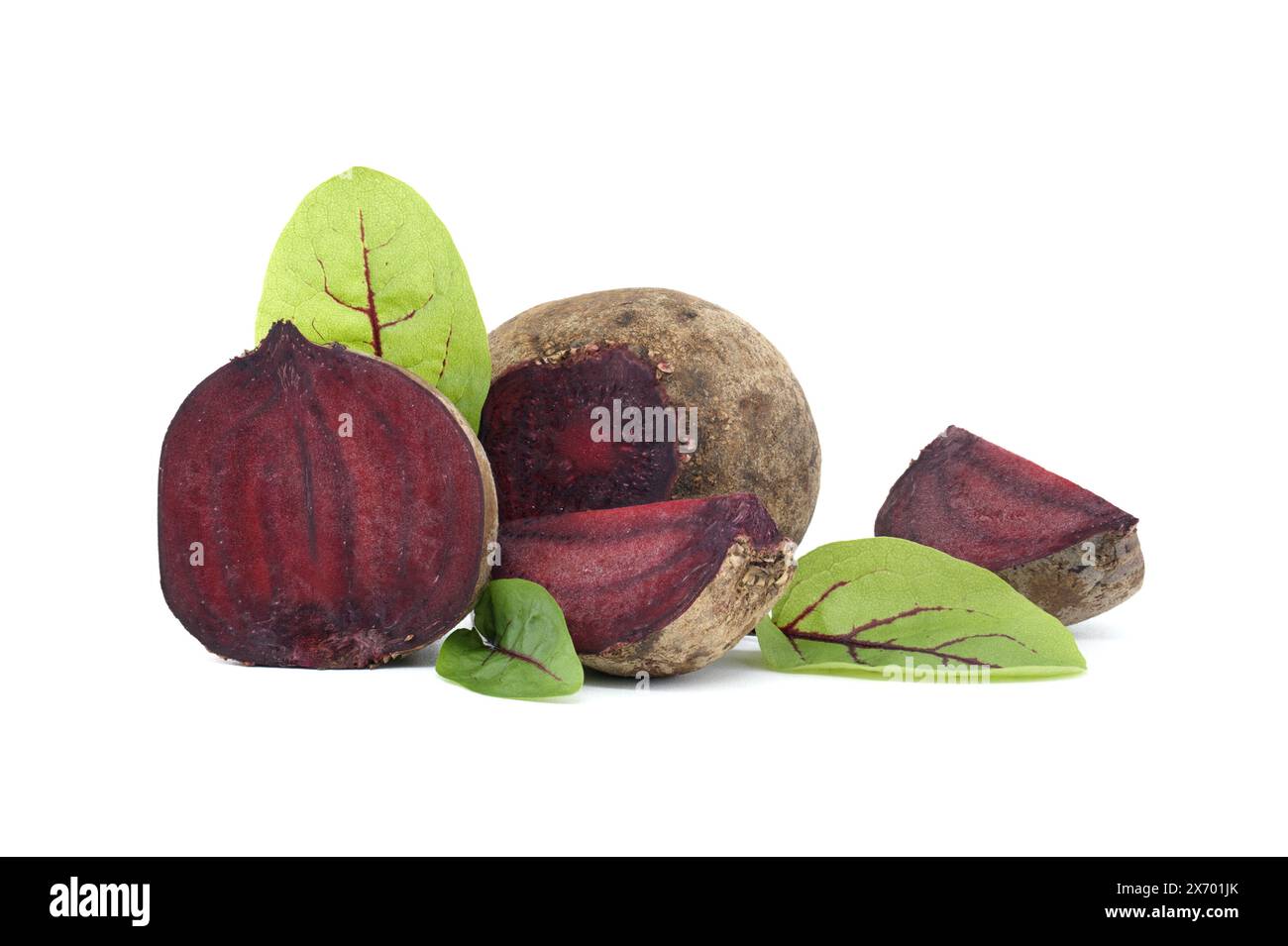 Slices of beetroot showing their purple interior arranged next to whole ...