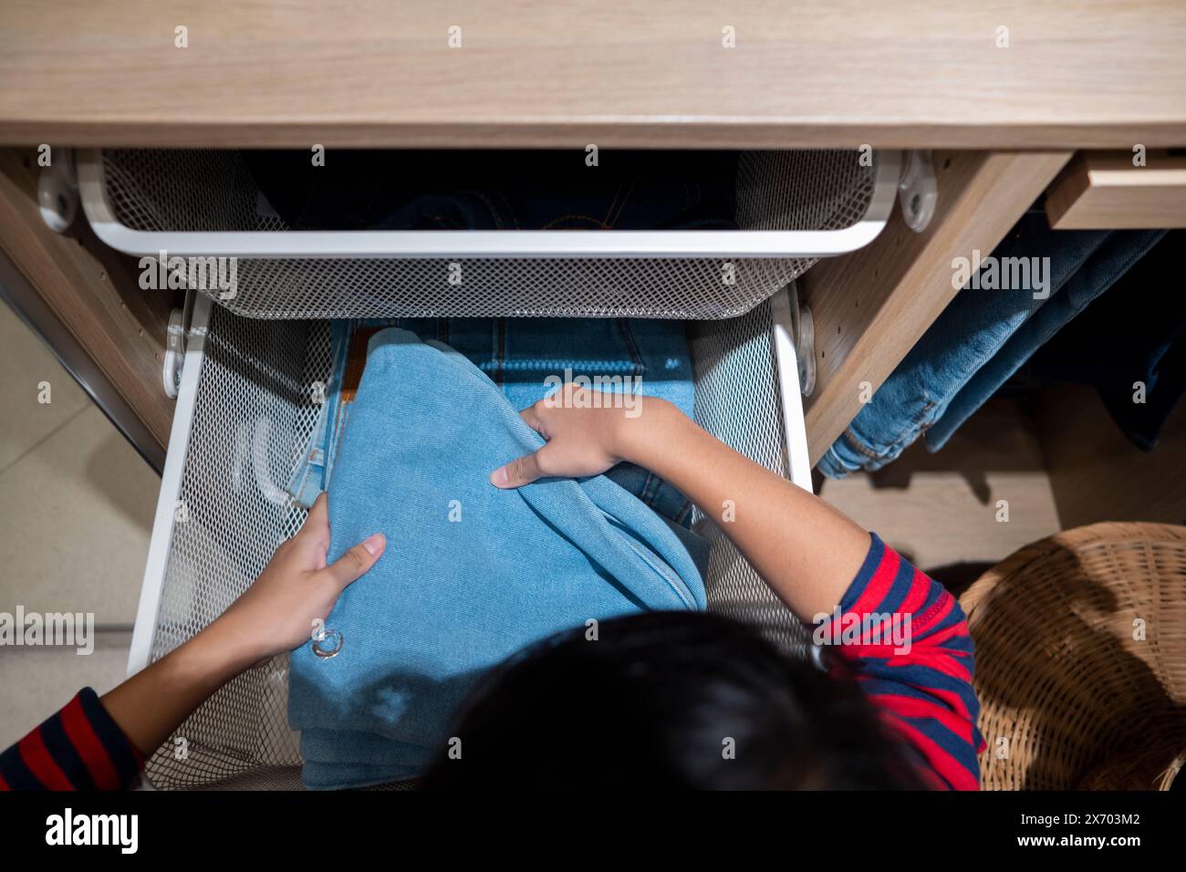 Indonesian pretty teenage girls choosing clothes in wardrobe shelf at ...