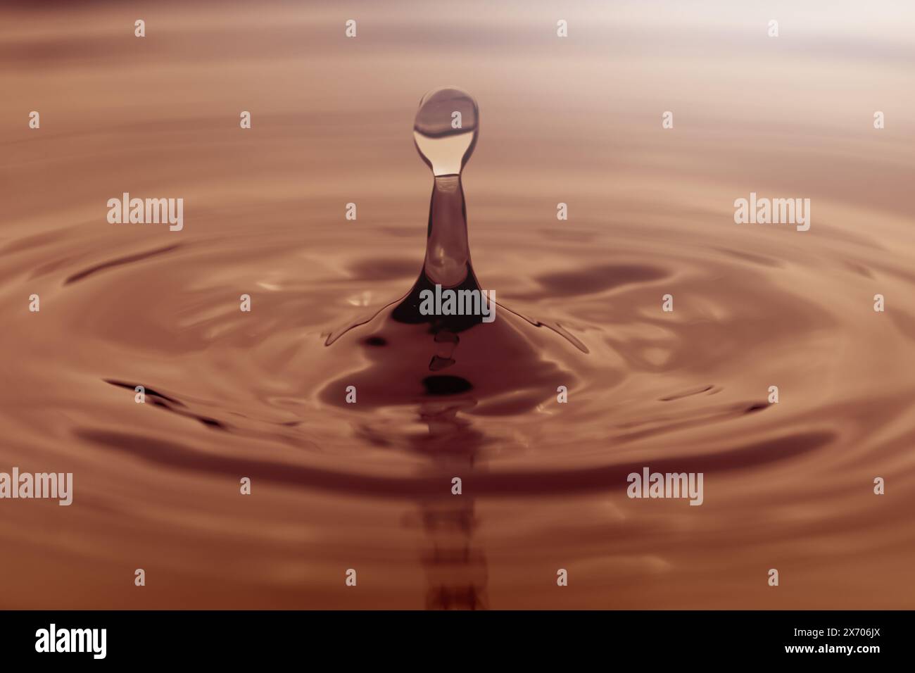 Close up melted liquid dark chocolate mixed with water for background ...