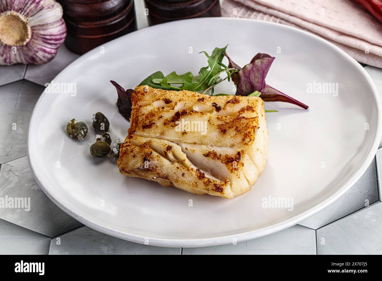 Roasted cod fish steak with salad leaves Stock Photo - Alamy
