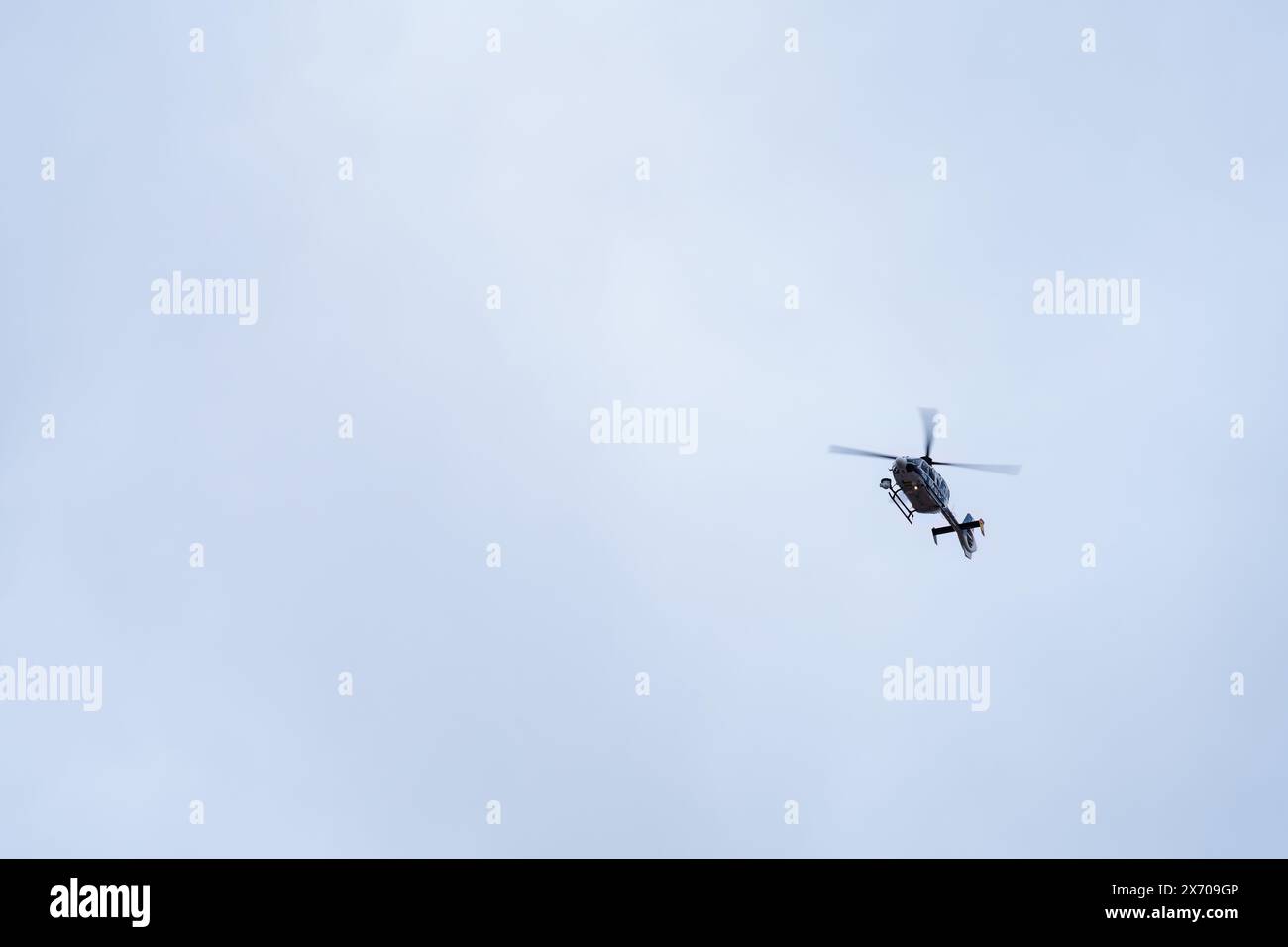 Police helicopter flying through the overcast sky in Spain Stock Photo ...
