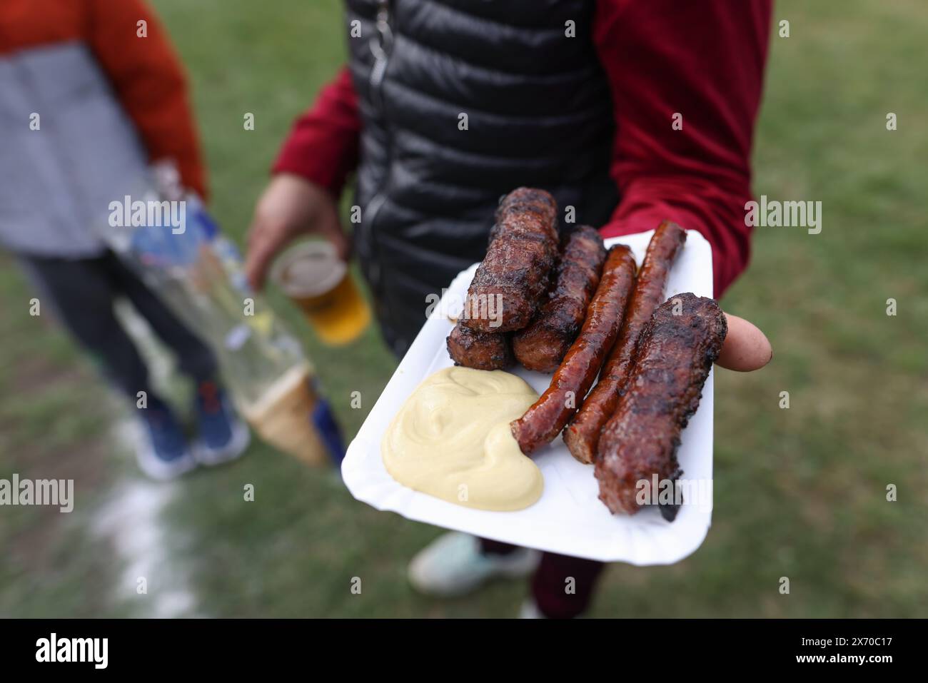 Person hold in hand Romanian traditional mici (mititei), grilled ground ...