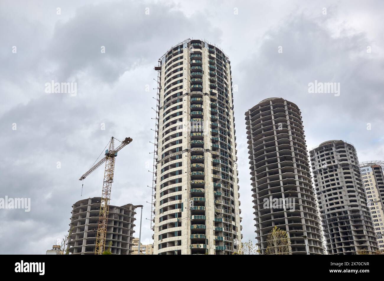 Tower crane building a house. Concrete building under construction ...