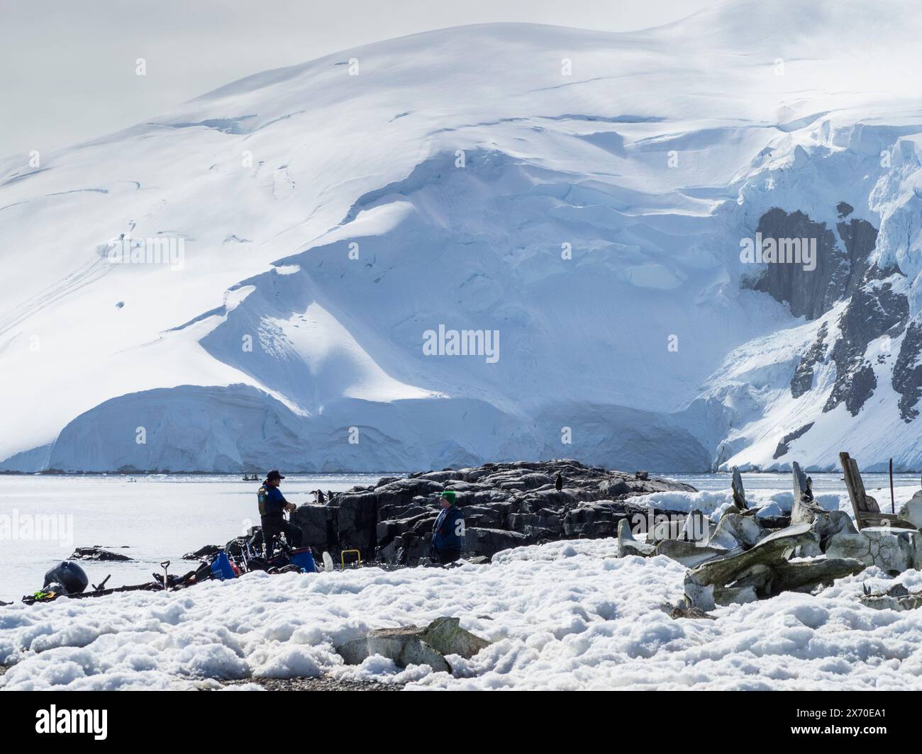Expedition guide and tourist on D’Hainaut Island, Mikkelsen Harbour ...