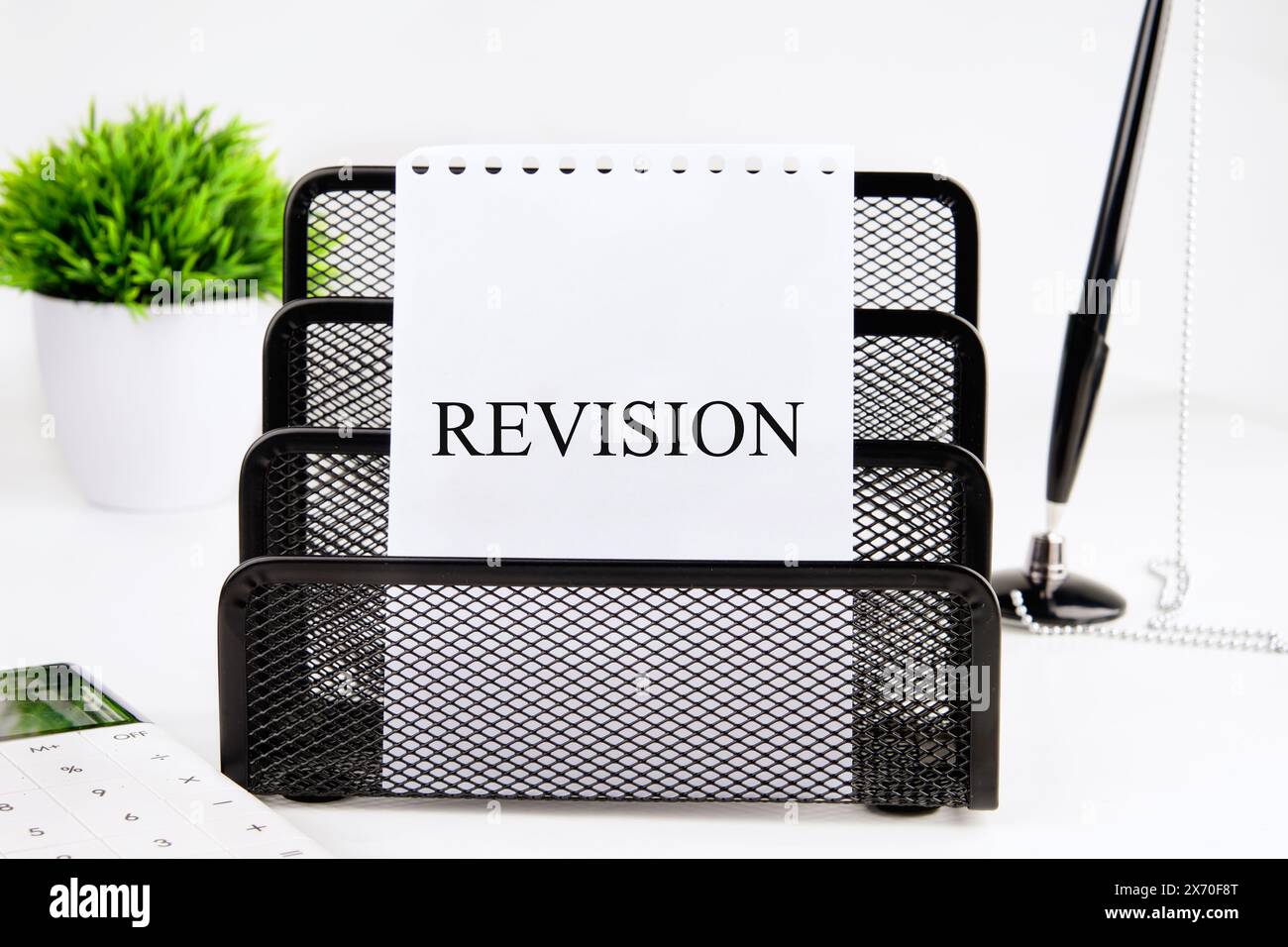 Conceptual revision symbol. REVISION word written on a blank sheet in a ...