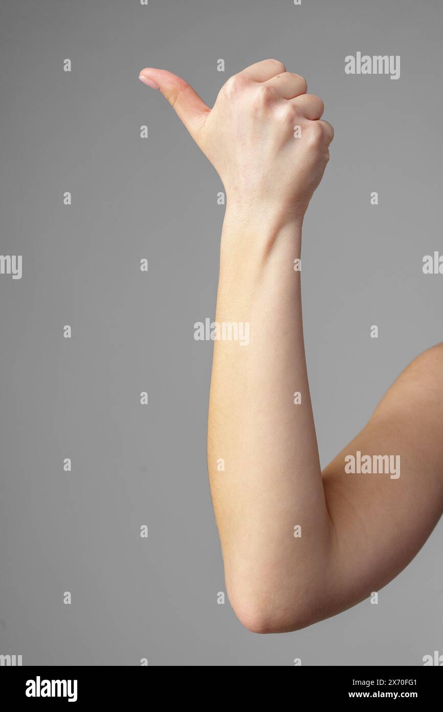 Woman Holding Arm Up in the Air with Gesture Stock Photo - Alamy