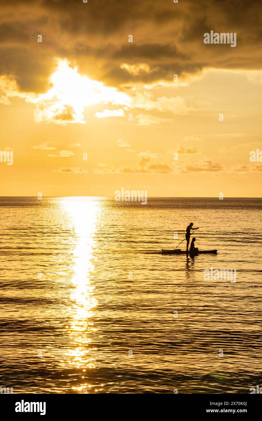 A couple paddleboarding at sunset in St. Martin Stock Photo - Alamy