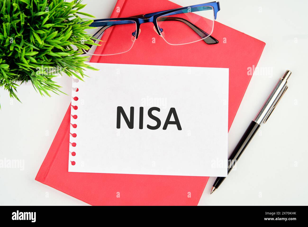 Image of NISA word written on a torn piece of paper lying on a notebook ...