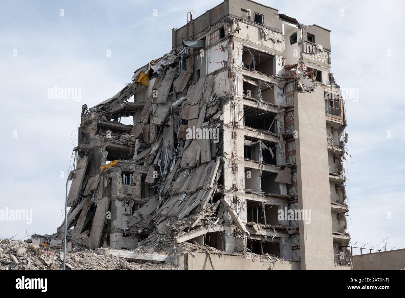 A partially collapsed building in an urban environment showing ...