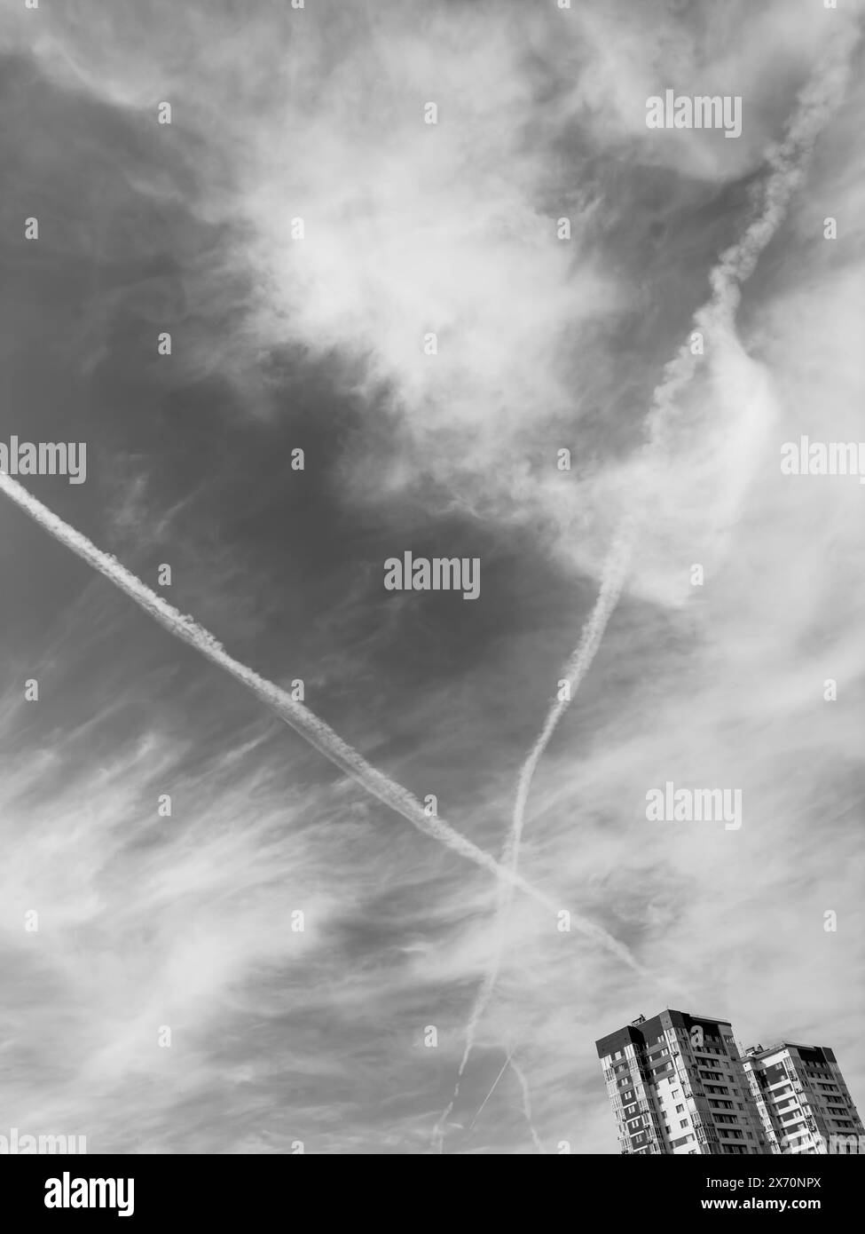 Black and white photo of high-rise buildings beneath a dramatic cloudy ...