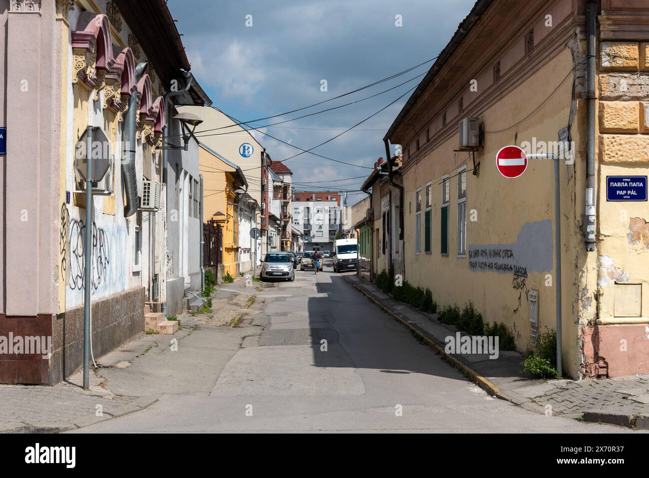 A street in downtown Novi Sad, with cars and a cyclist. April 2024 ...
