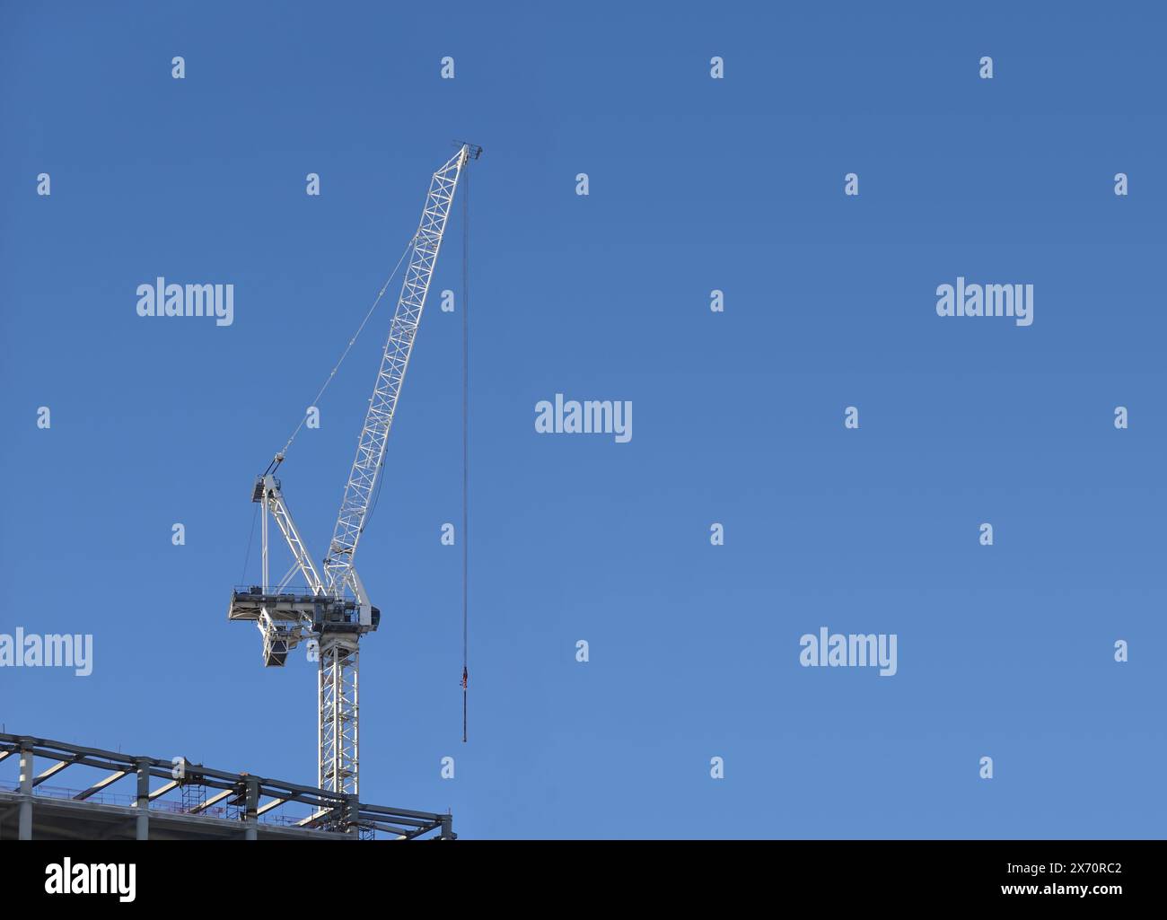 Hoisting tower crane on the top section being constructed of modern ...