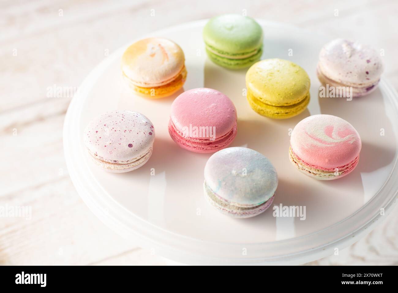 Multi-colored macaroons illuminated by sun rays casting their shadow ...