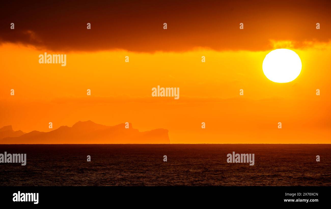 Serra de Tramuntana range, on the island of Mallorca, backlit at sunset ...