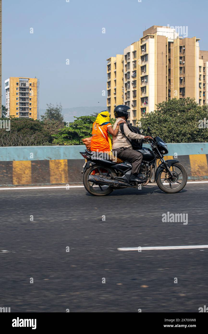 indian couple driving with scooter woman sitting at rear back seat ...