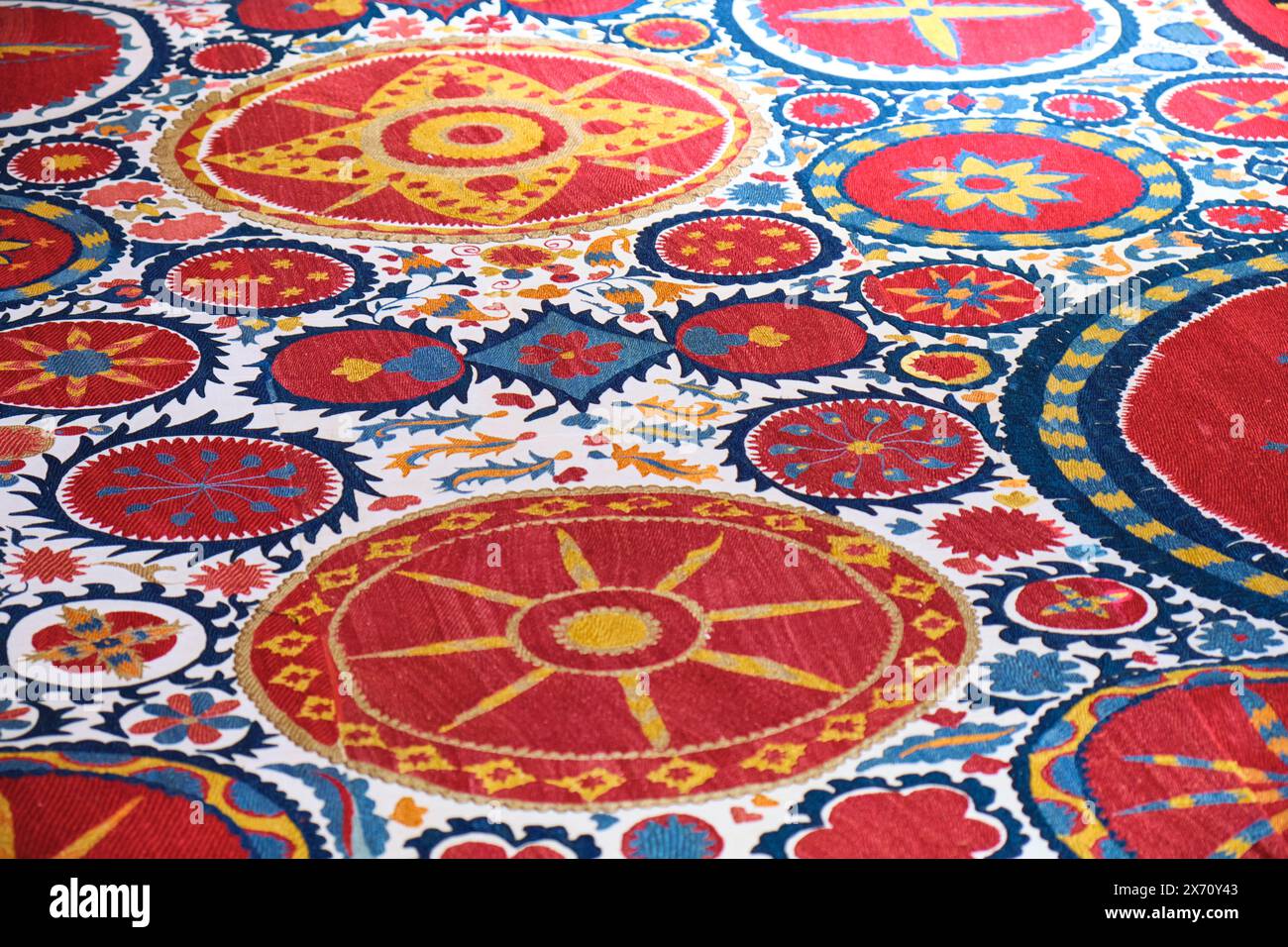 Detail view of a finished, huge, red, elaborate suzani textile. At a ...