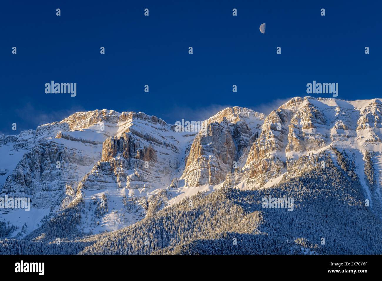 Sunrise over the Cadí mountain range, with the waning Moon, seen from ...
