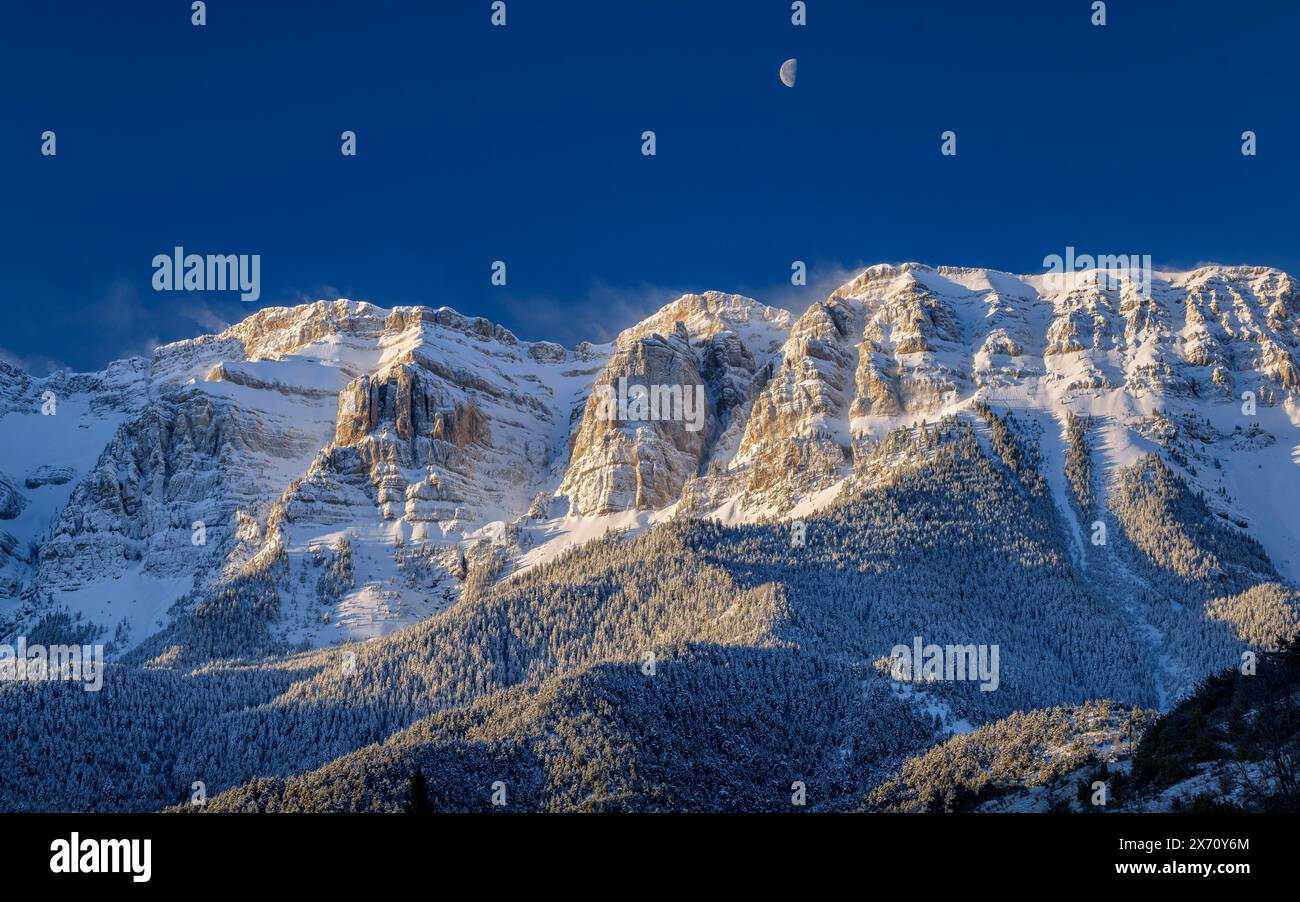 Sunrise over the Cadí mountain range, with the waning Moon, seen from ...