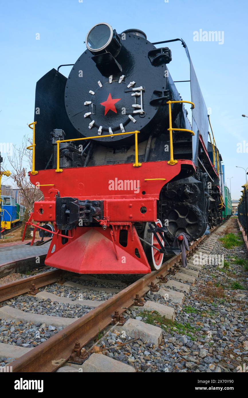 View of the front of an old steam, black locomotive with red star and ...